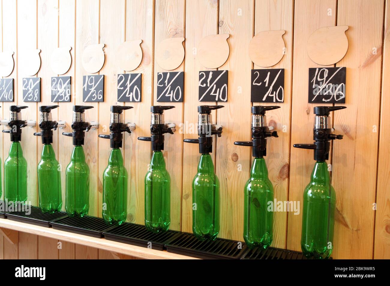 Large simultaneous spilling beer in the bar. The bar of wood. Wooden ...