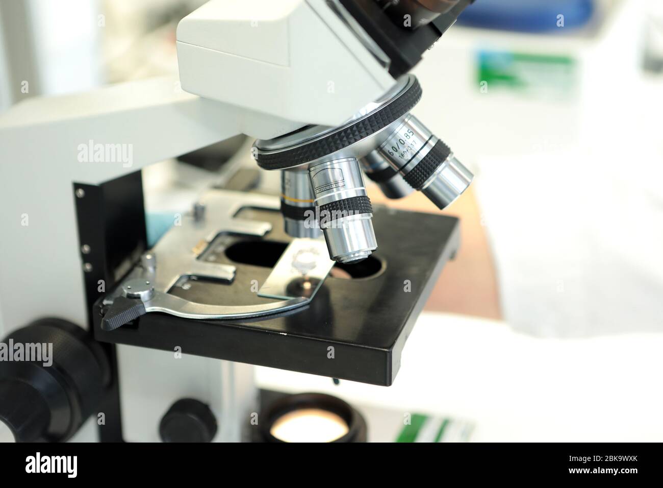 A woman and a man study the structure of the drug pellets under a ...