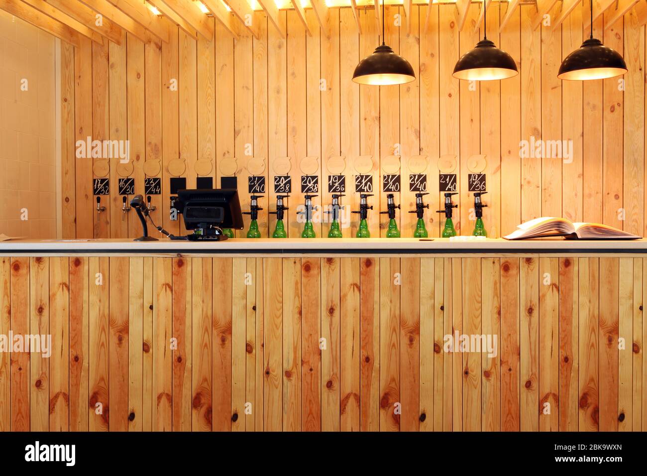 Large simultaneous spilling beer in the bar. The bar of wood. Wooden ...