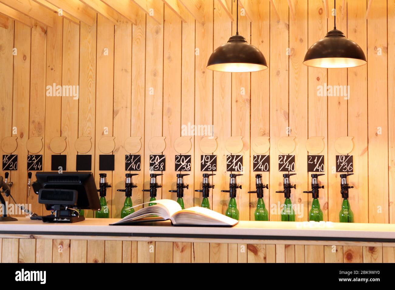 Large simultaneous spilling beer in the bar. The bar of wood. Wooden ...
