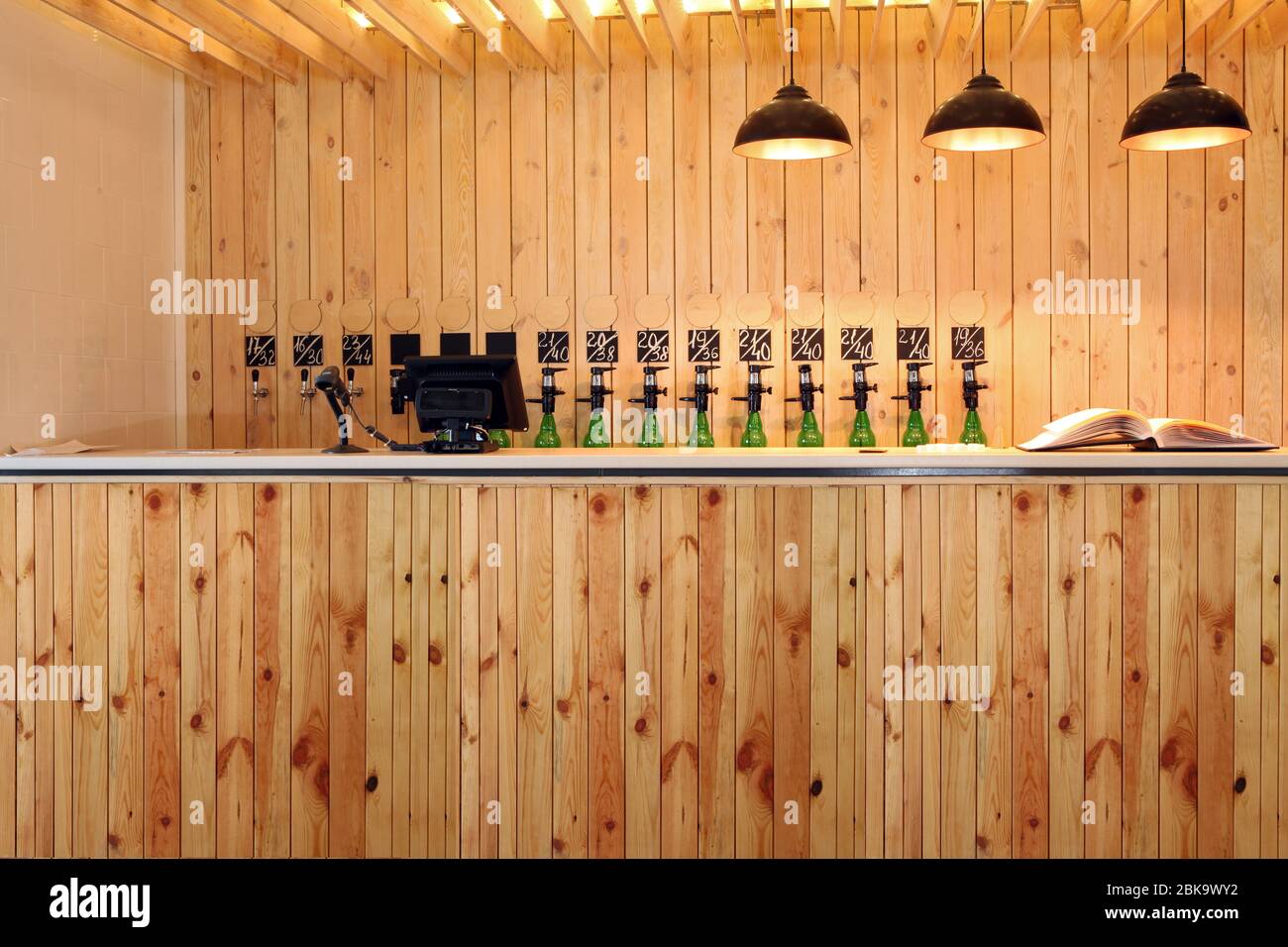 Large simultaneous spilling beer in the bar. The bar of wood. Wooden ...