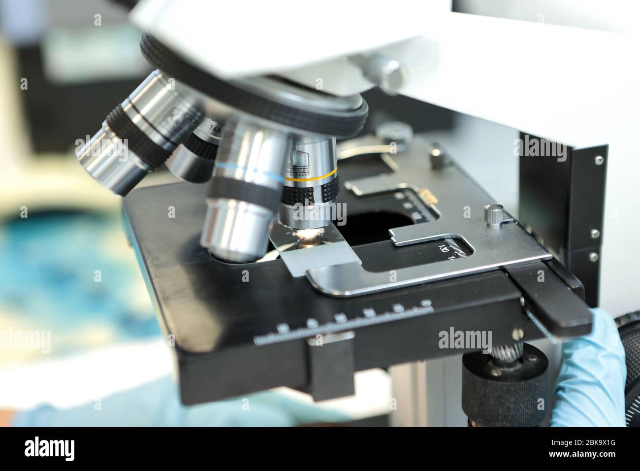 A woman and a man study the structure of the drug pellets under a ...
