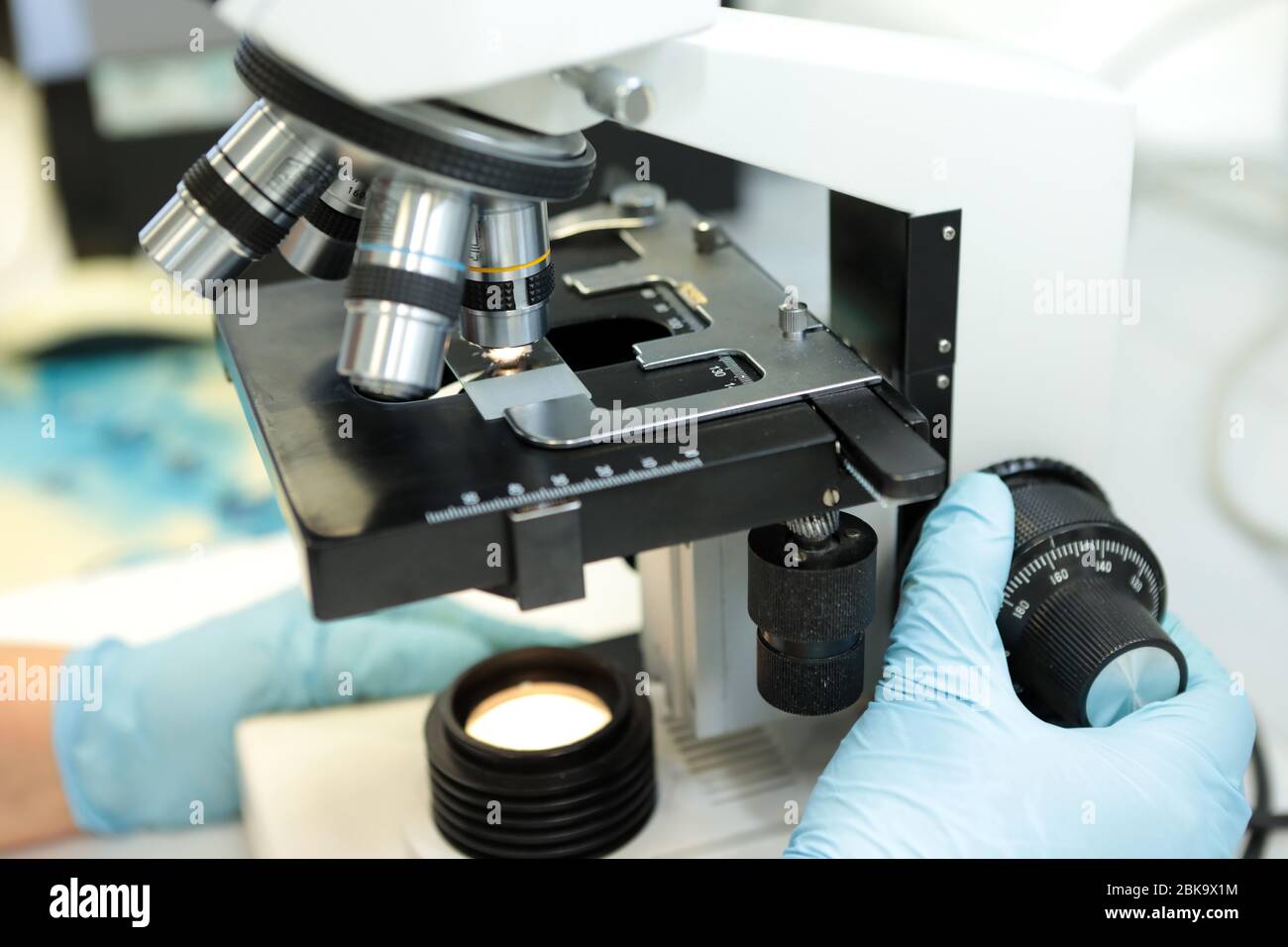 A woman and a man study the structure of the drug pellets under a ...