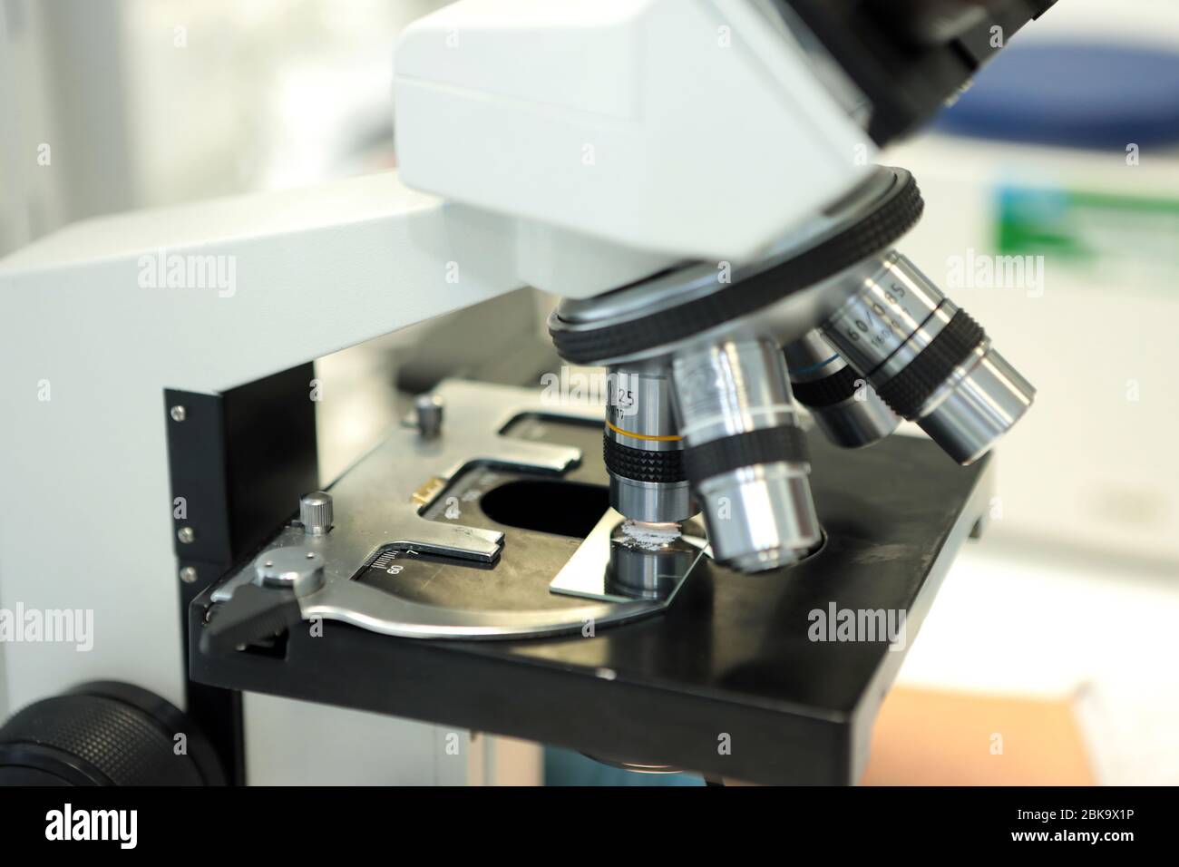 A woman and a man study the structure of the drug pellets under a ...