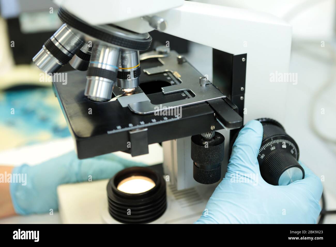 A woman and a man study the structure of the drug pellets under a ...