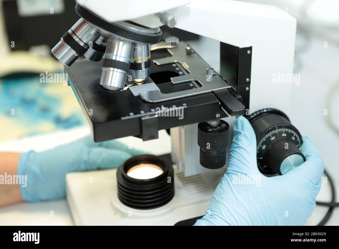 A woman and a man study the structure of the drug pellets under a ...