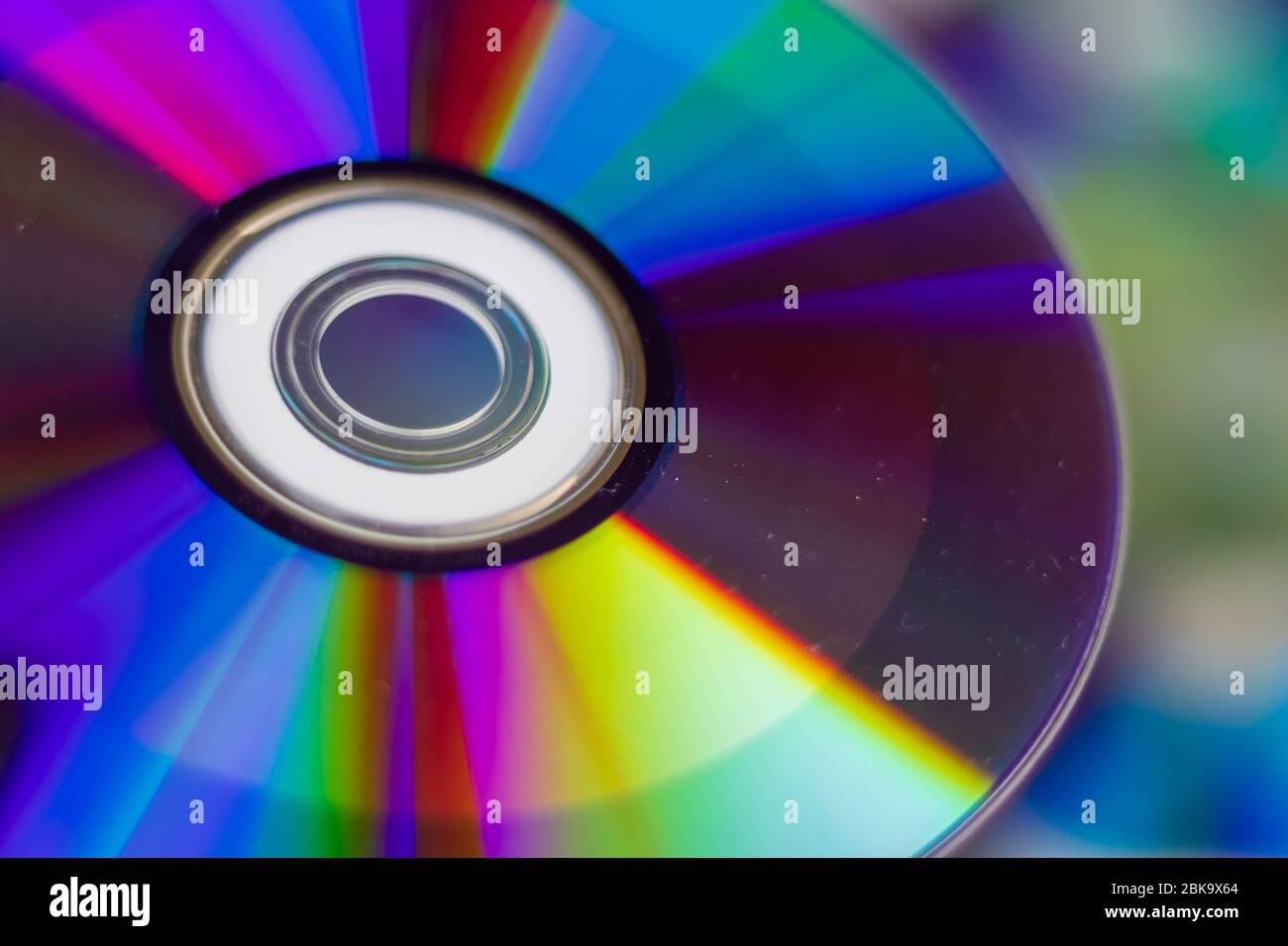 Compact Disc. Holding a CD in hands. The back side of the CD reflects ...