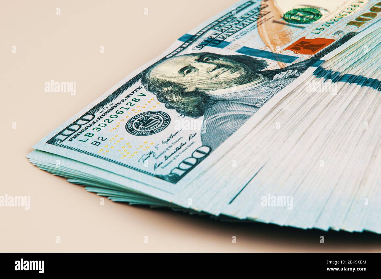 A pack of dollars. A large wad of hundred-dollar bills is lying on a ...