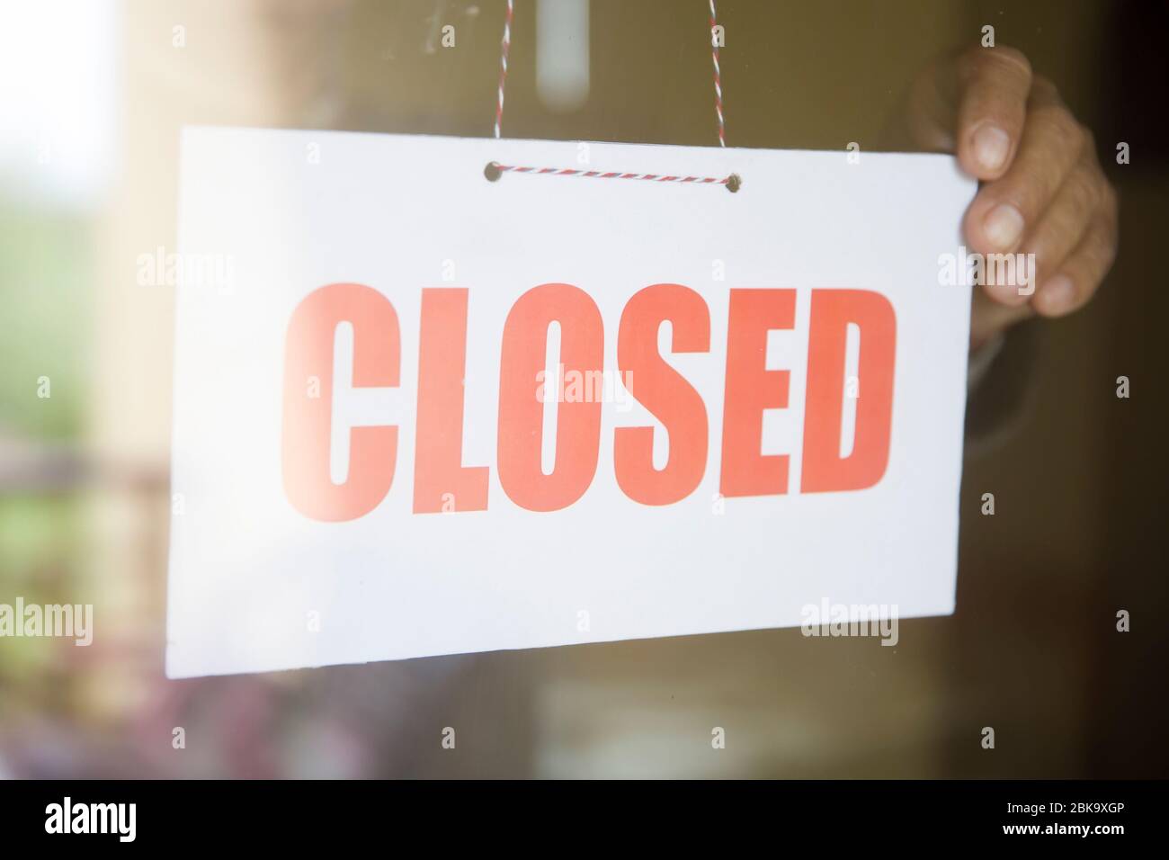 Business store owner turning closed sign at glass shop doorway Stock ...