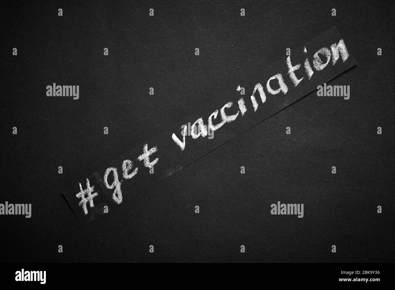 Vaccination inscription on black paper background. Immunization of the ...