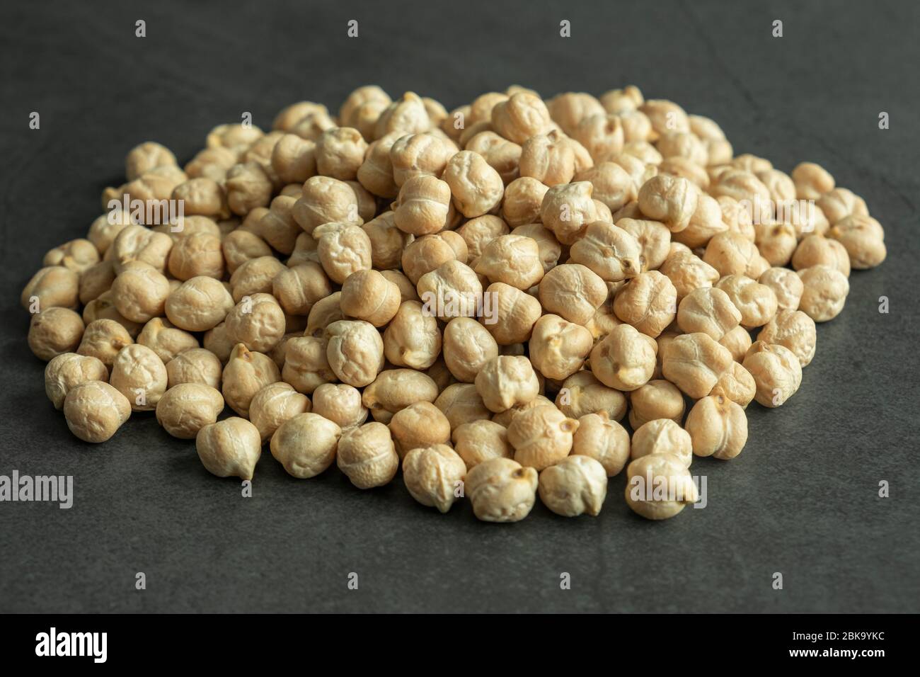 Raw chickpea heap on stone, concrete background. Healthy and organic ...