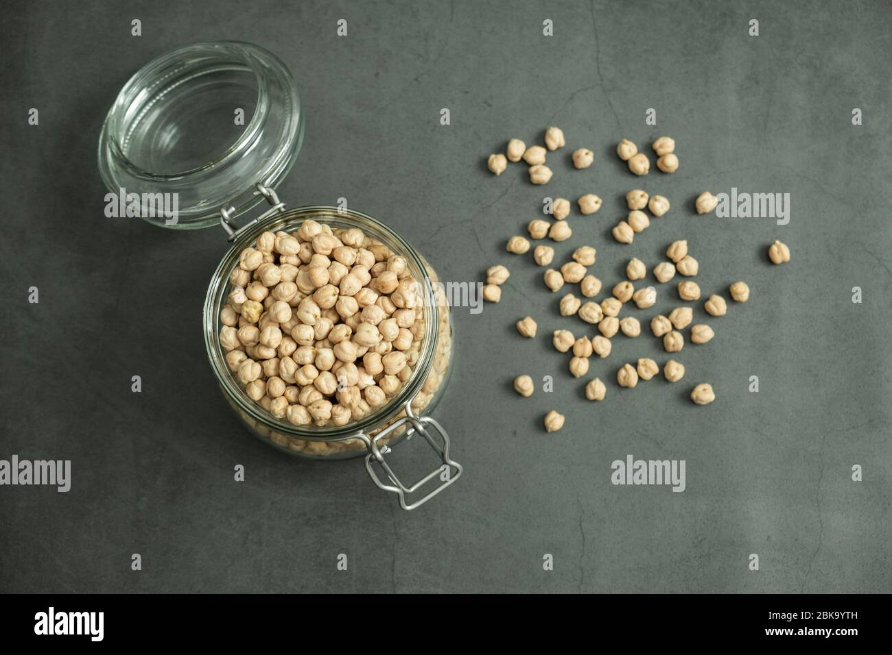 Chickpea in glass jar on stone, concrete background. Raw, healthy ...