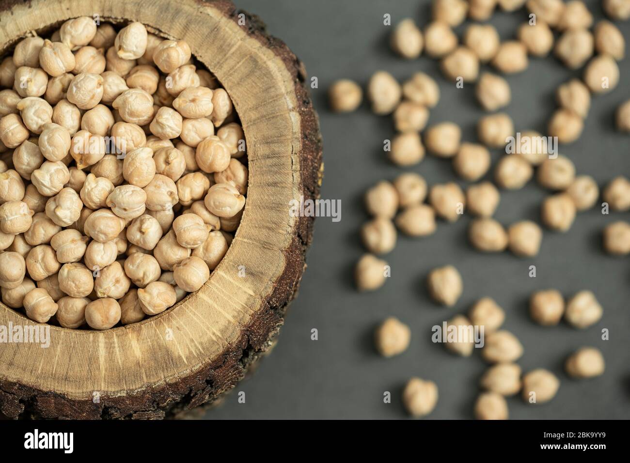 Chickpea in wooden bowl on stone, concrete background. Healthy, raw ...