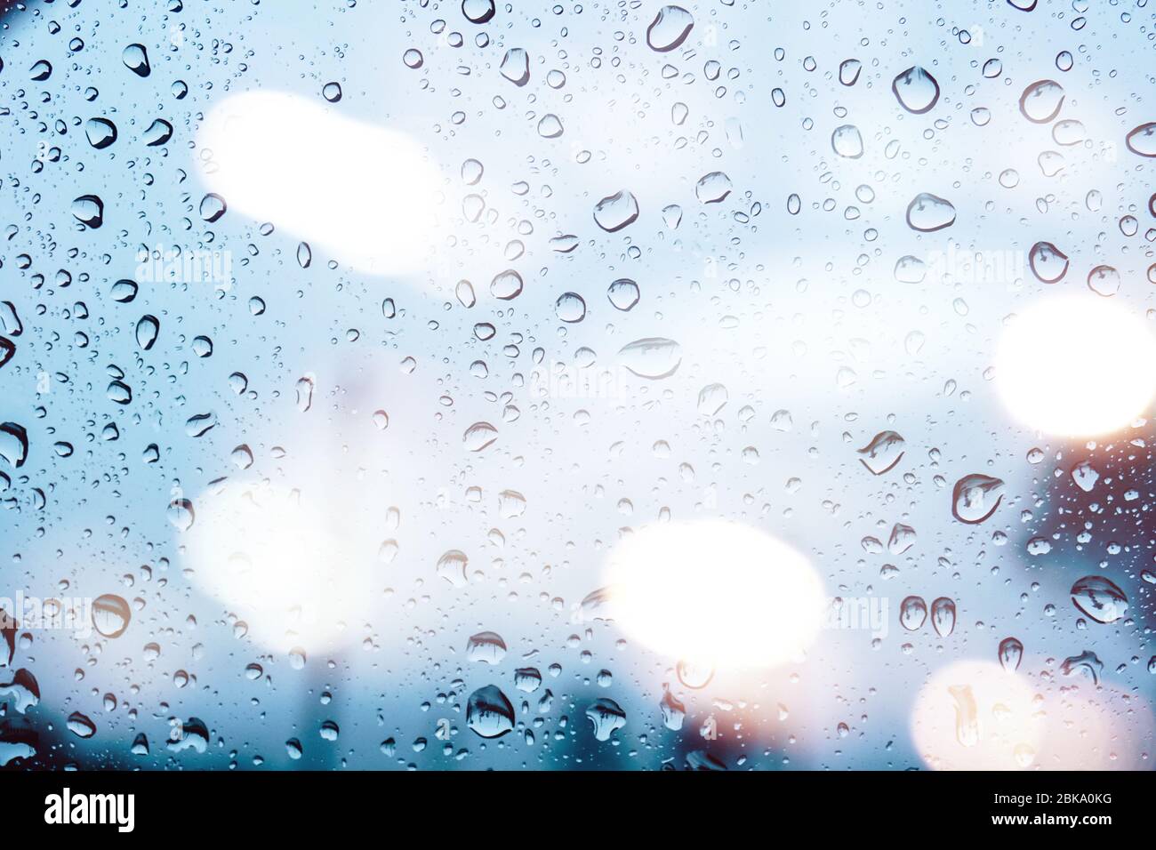 water drops on glass window with bokeh lights Stock Photo - Alamy