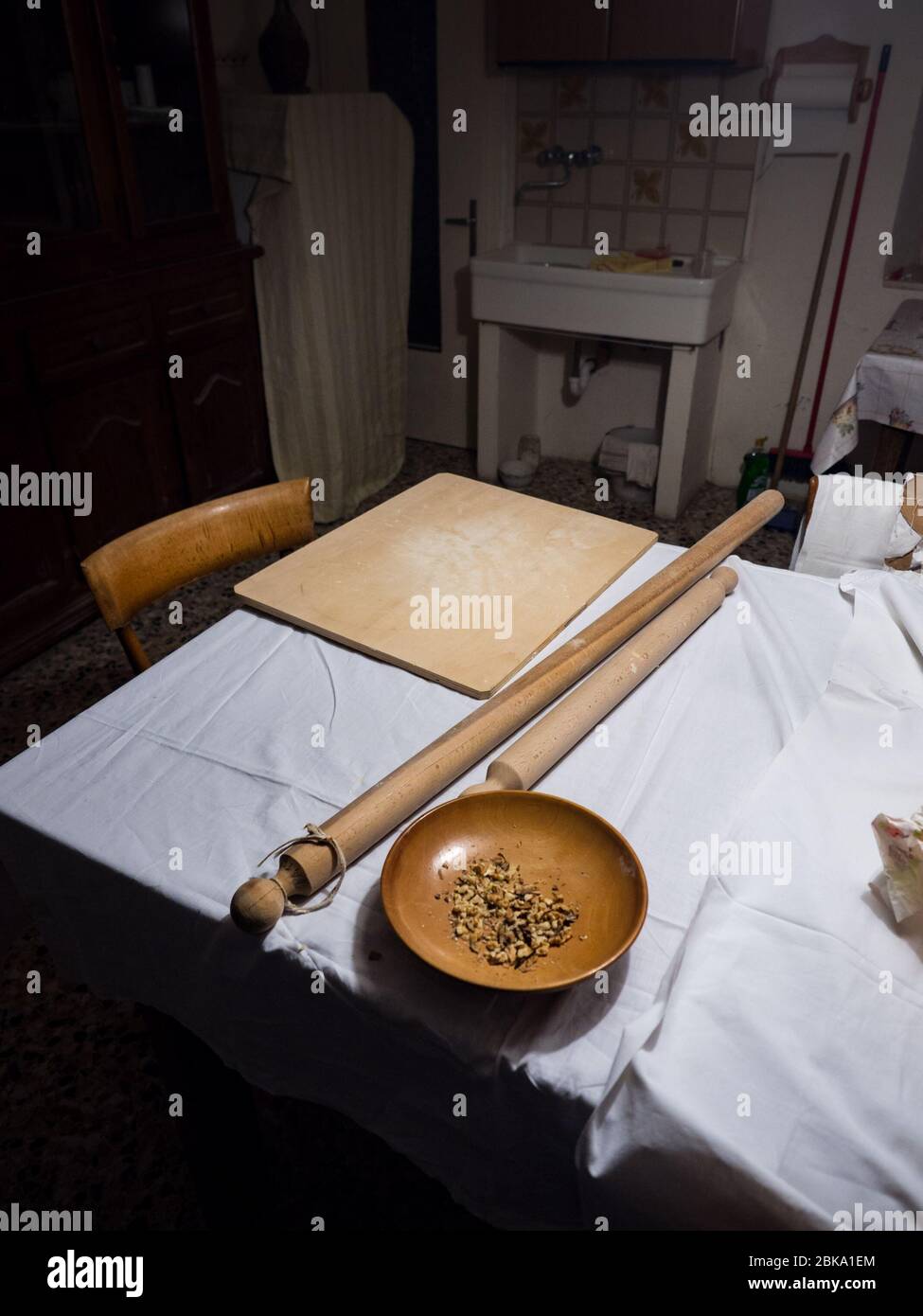 Wooden tools for homemade pasta in an old kitchen of an Italian village ...