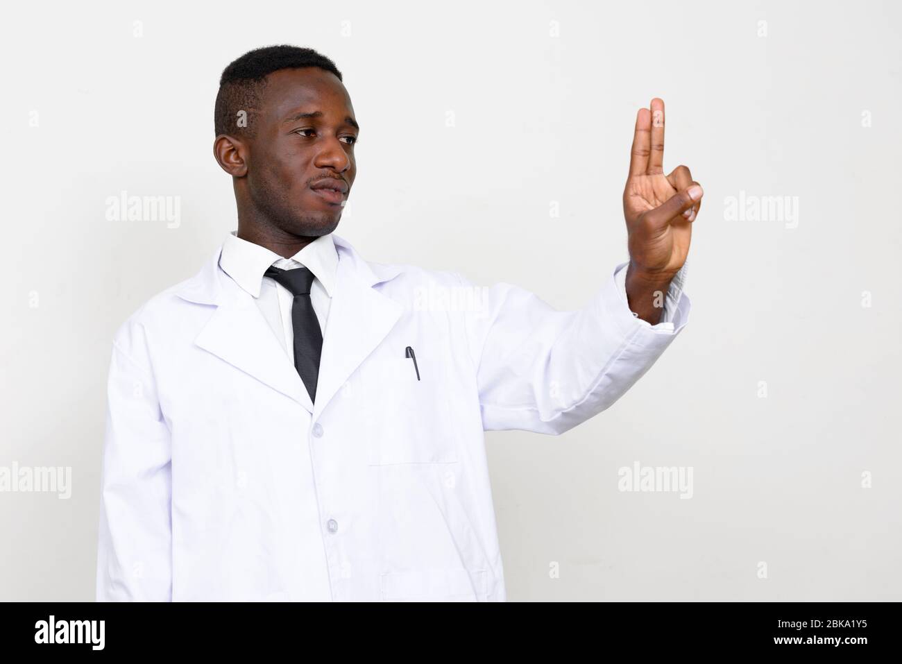 Portrait of young African man doctor touching something Stock Photo - Alamy