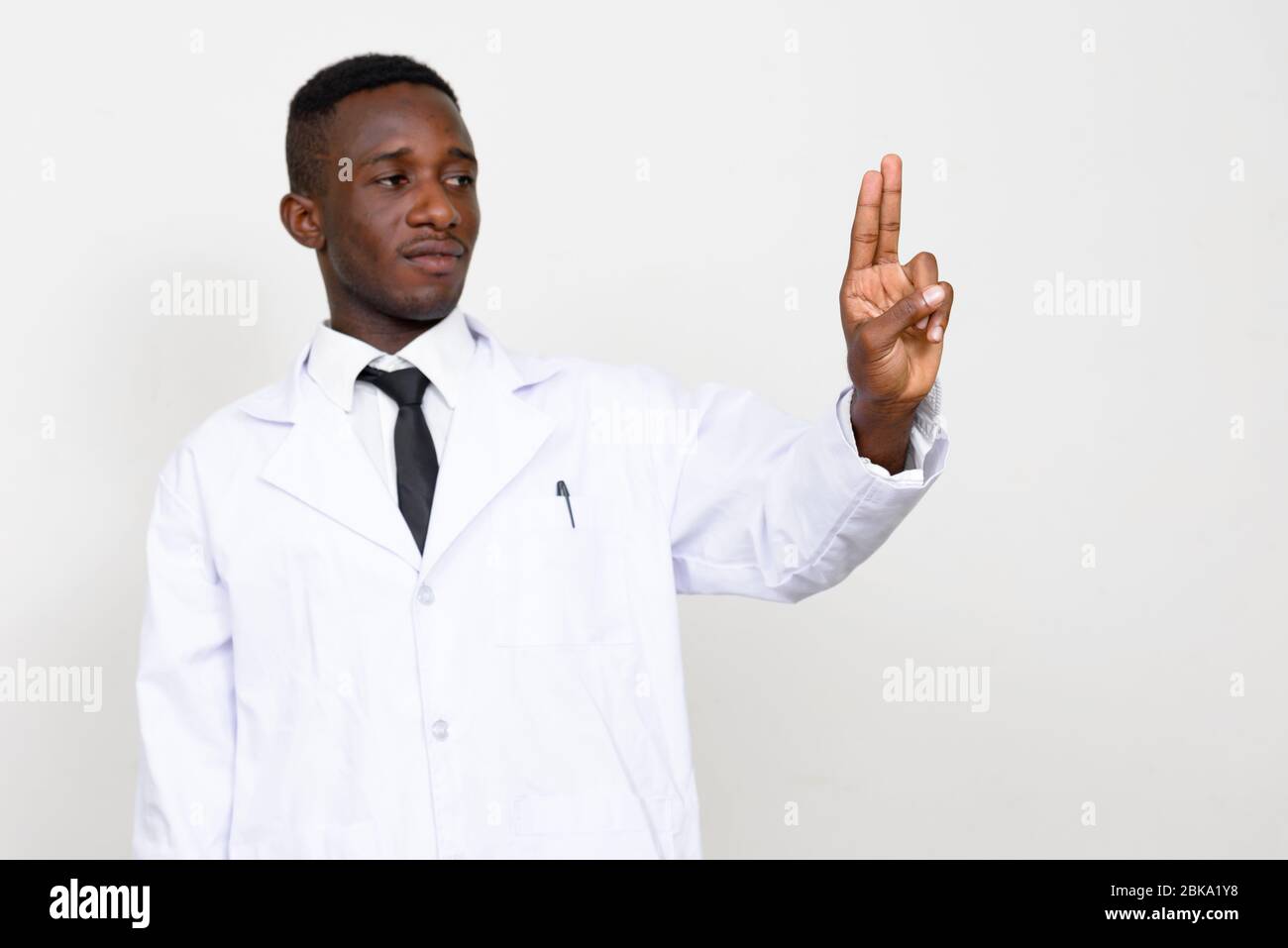 Portrait of young African man doctor touching something Stock Photo - Alamy