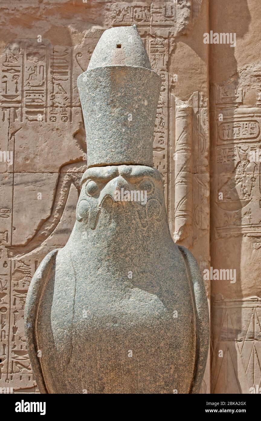 Ancient egyptian temple of Horus in Edfu with closeup of giant statue ...