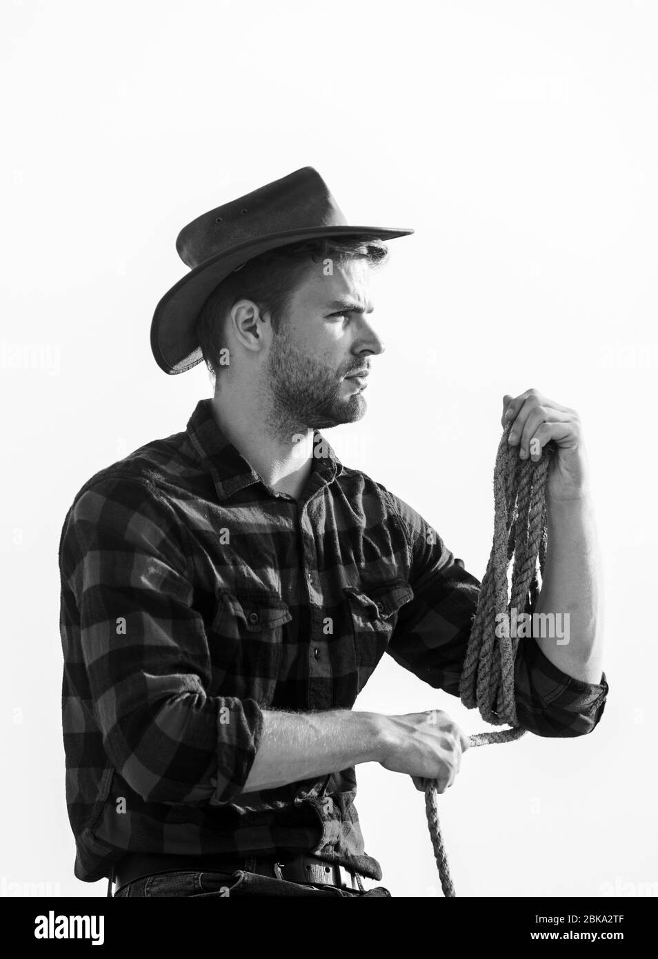 Farming concept. Handsome man in hat and rustic style outfit. Keep ...