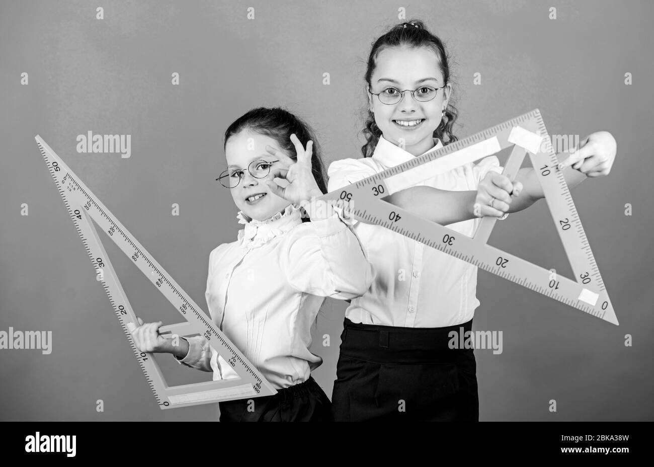Pupil cute girls with big rulers. STEM school disciplines. math lesson ...