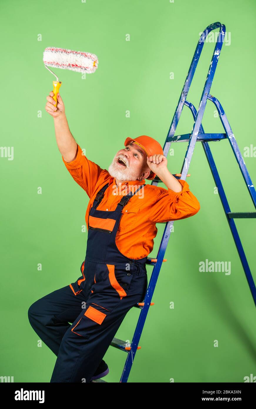 Painter man staircase. To make repairs. man in working clothes painting ...