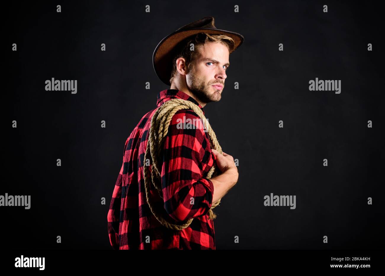 Western life. Man wearing hat hold rope. Lasso tool of American cowboy ...