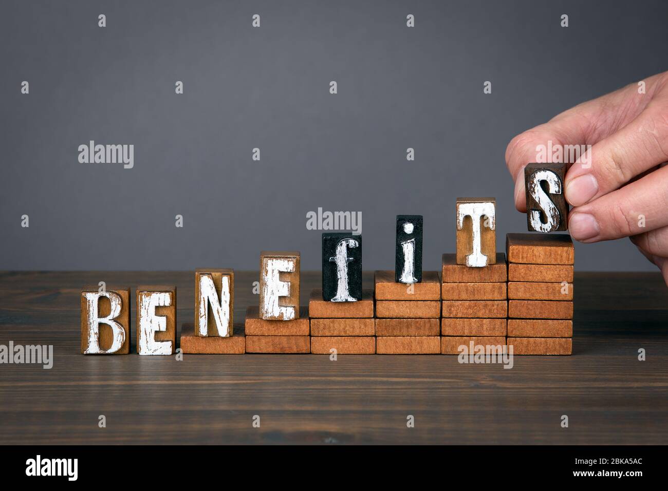 BENEFITS concept. Wooden alphabet letters on steps. Gray background ...