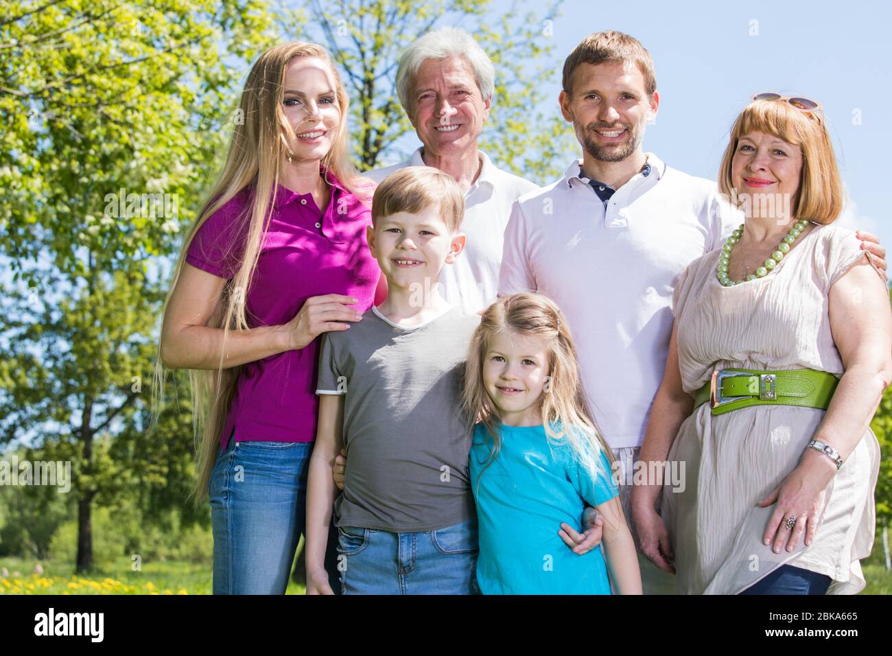 Multigeneration family portrait outdoors. Happy parents with two ...