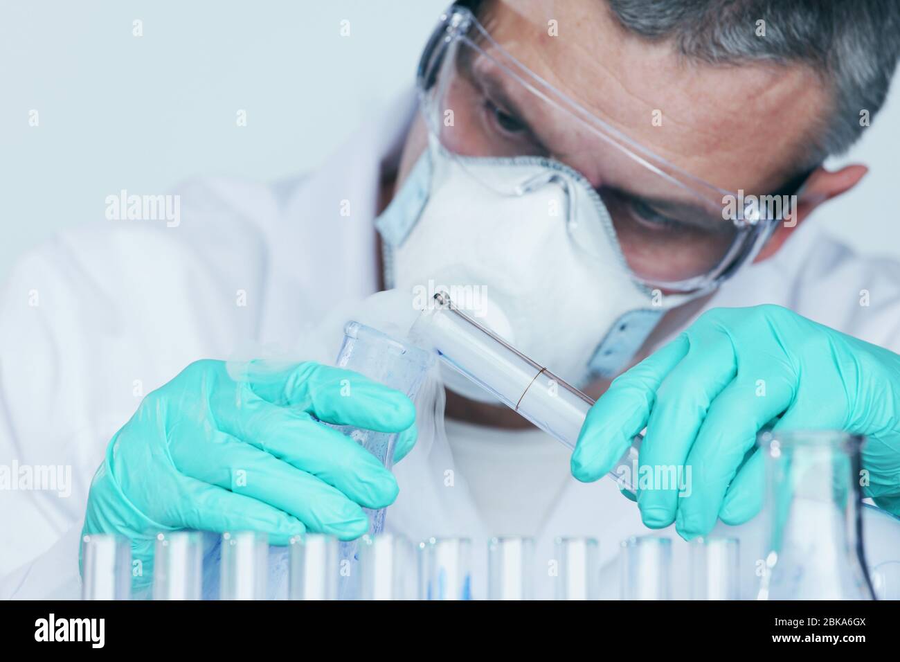 Mature male researcher carrying out scientific research in a lab ...