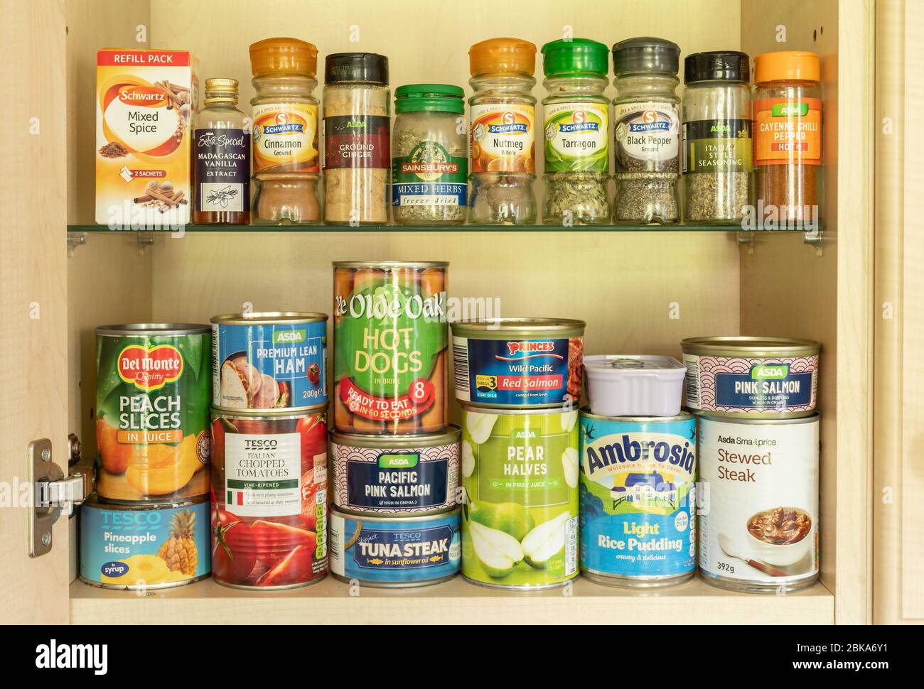 Tinned food (canned food) in a kitchen store cupboard. Tins, cans, jars ...