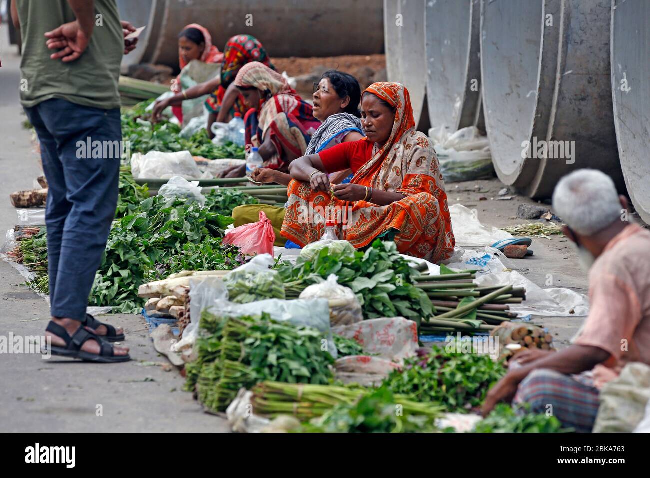 A group of low income people selling vegetables on the street of ...