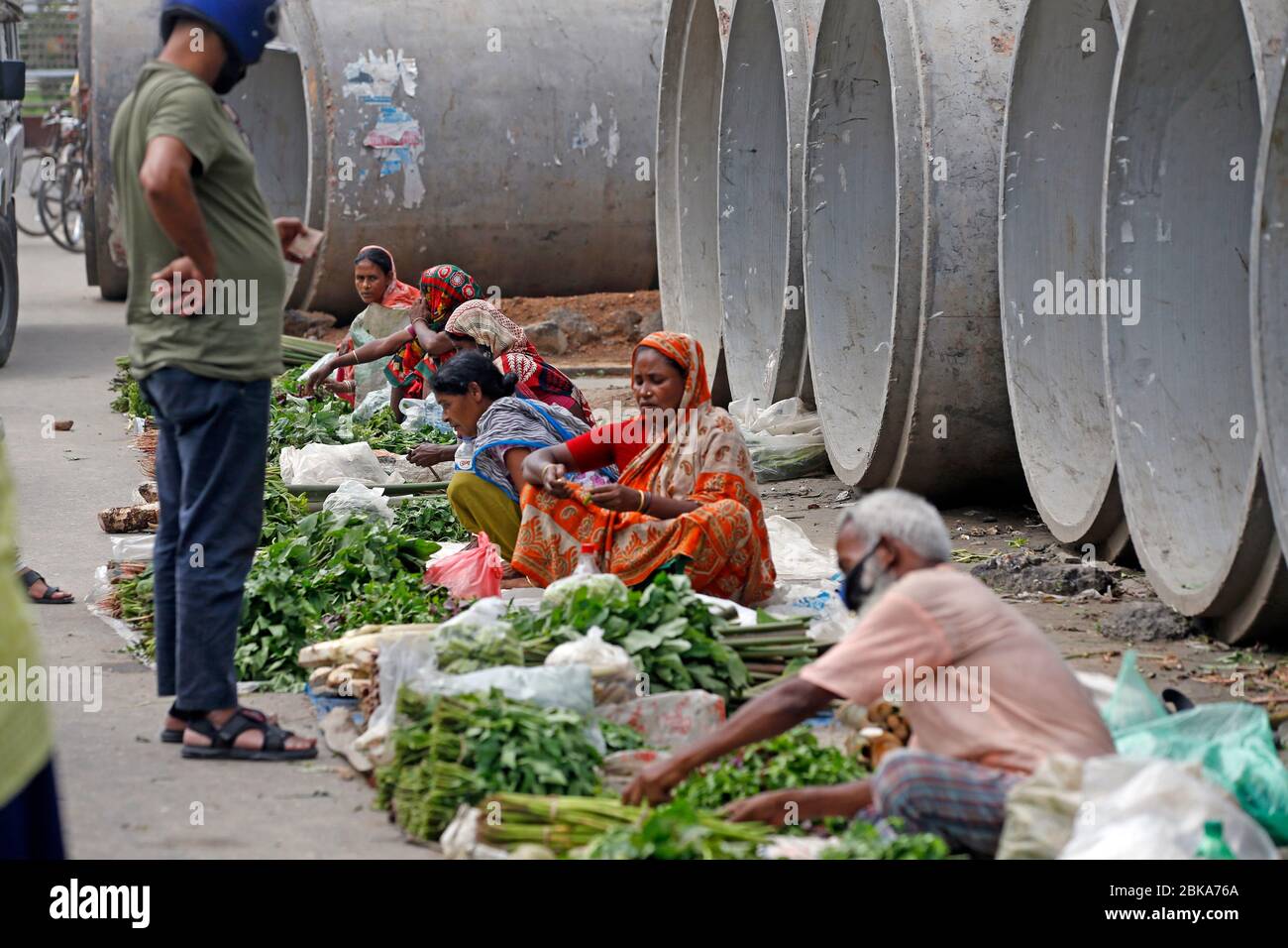A group of low income people selling vegetables on the street of ...