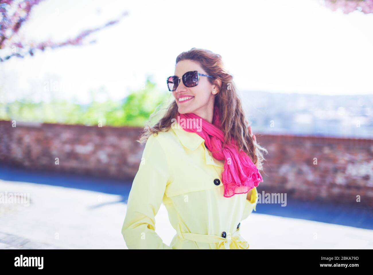 Young redhead positive woman walking in park with toothy smile looking ...