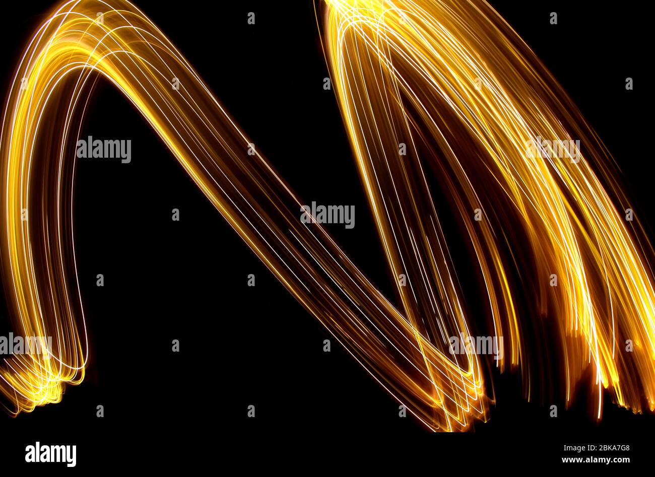 Long exposure photograph of neon gold colour in an abstract swirl ...