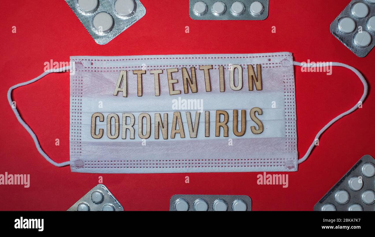 ATTENTION CORONAVIRUS is wording on protective medical mask. pills in ...