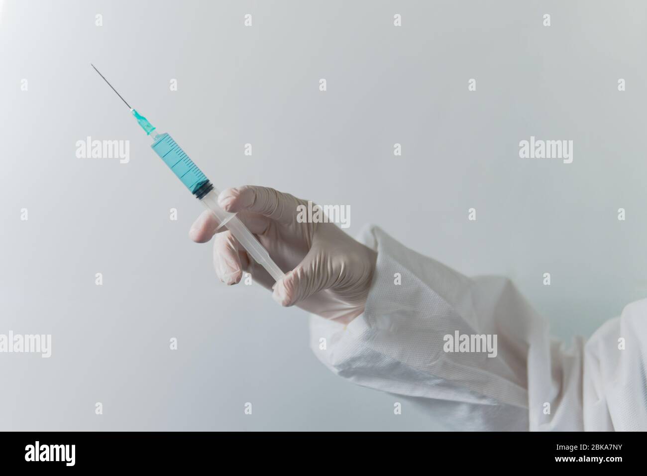 Nurse doctor holding medical injection syringe wearing surgical rubber ...