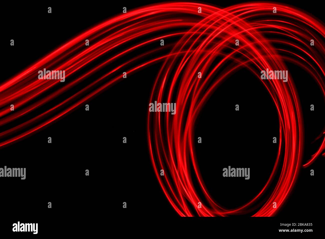 Long exposure photograph of neon colour in an abstract swirl, parallel ...
