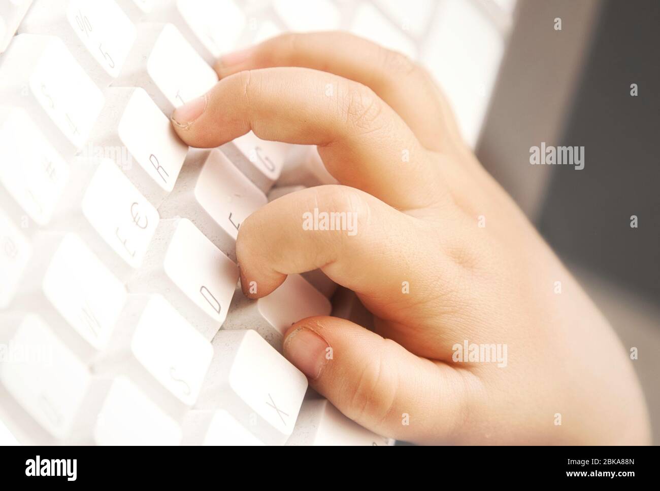 Child hand playing with a computer keyboard Stock Photo - Alamy