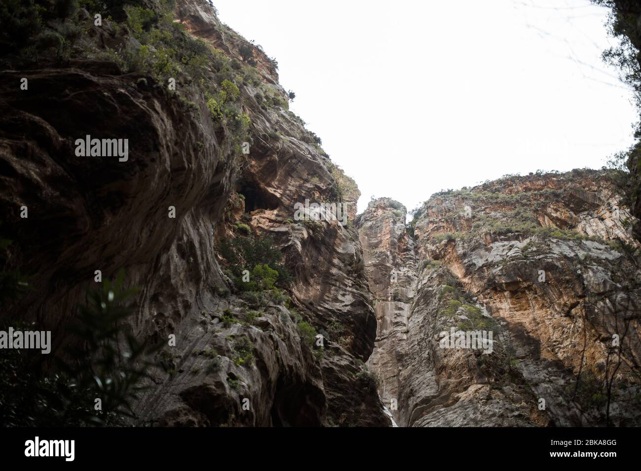 large rocks hang from below Stock Photo - Alamy