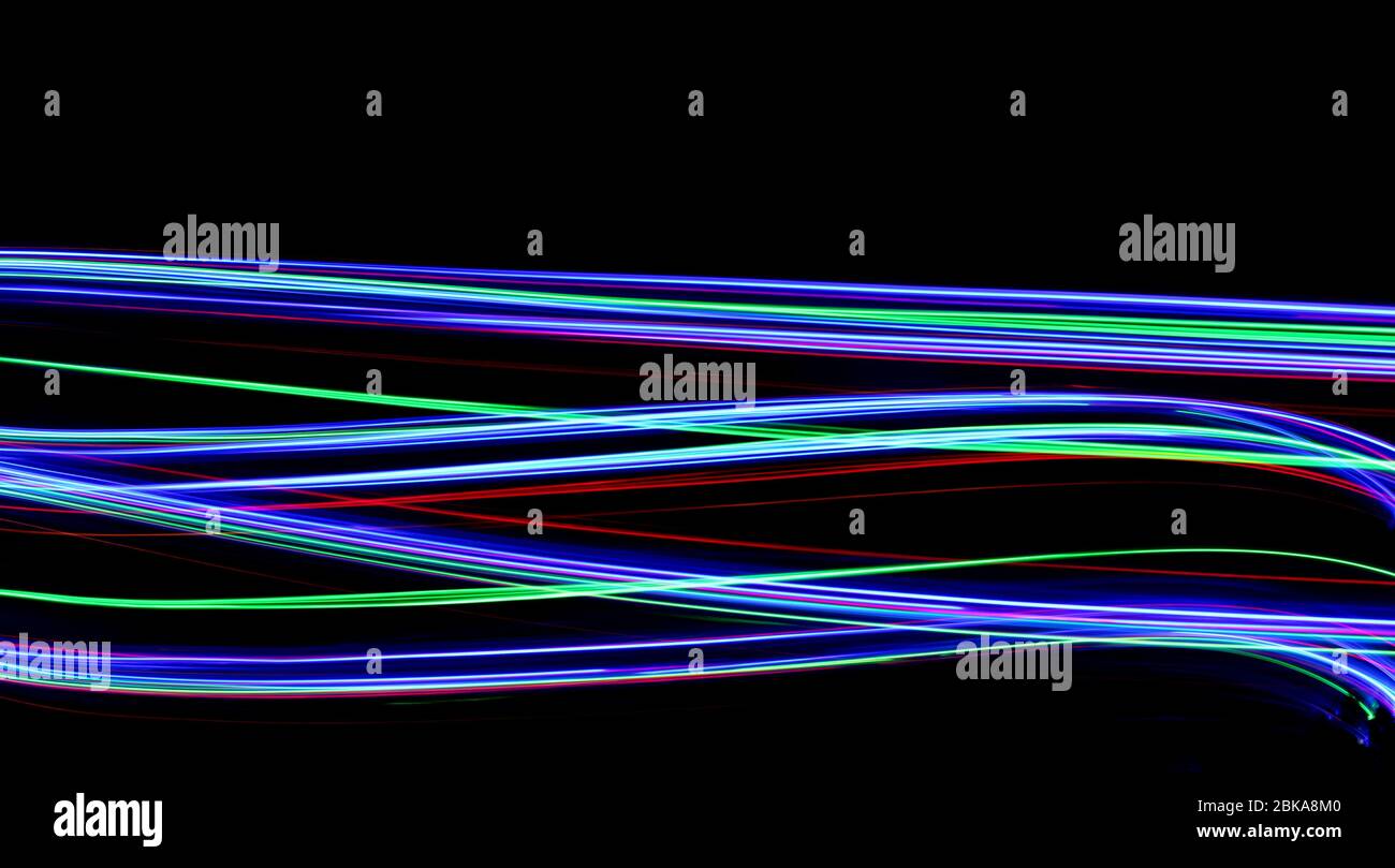 Long exposure photograph of neon colour in an abstract swirl, parallel ...