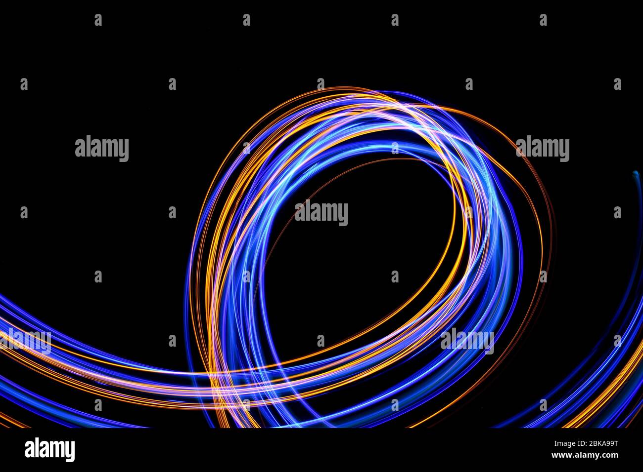 Long exposure photograph of neon colour in an abstract swirl, parallel ...