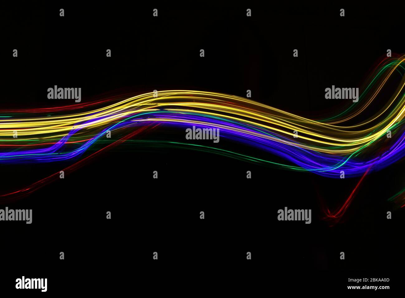 Long exposure photograph of neon colour in an abstract swirl, parallel ...