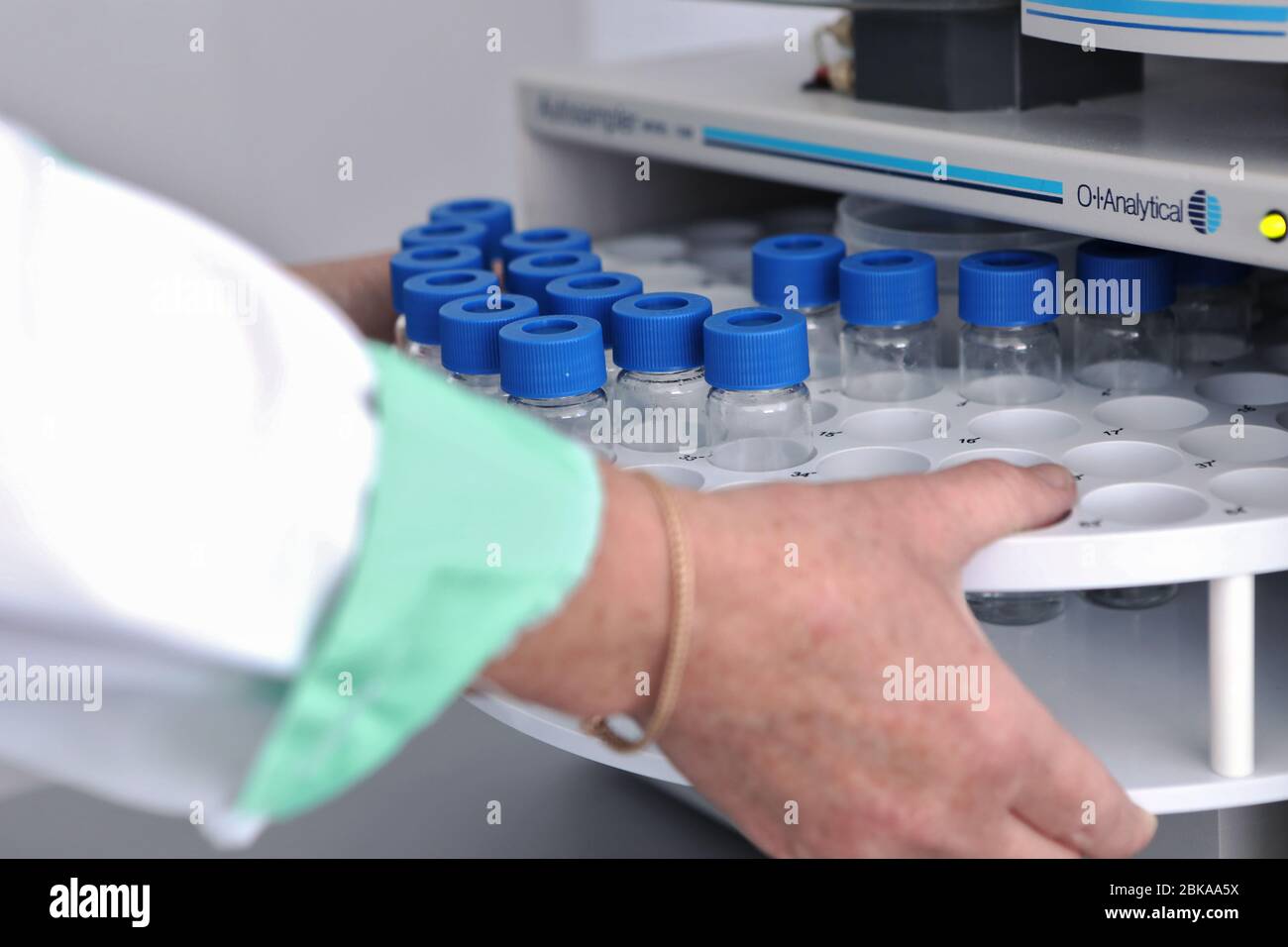 An analyzer with a rotary autosampler at work in a factory. Production ...