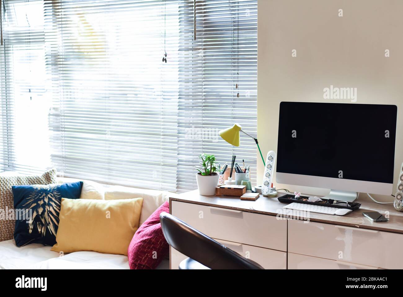 Home working area with office desk set up in living room Stock Photo ...