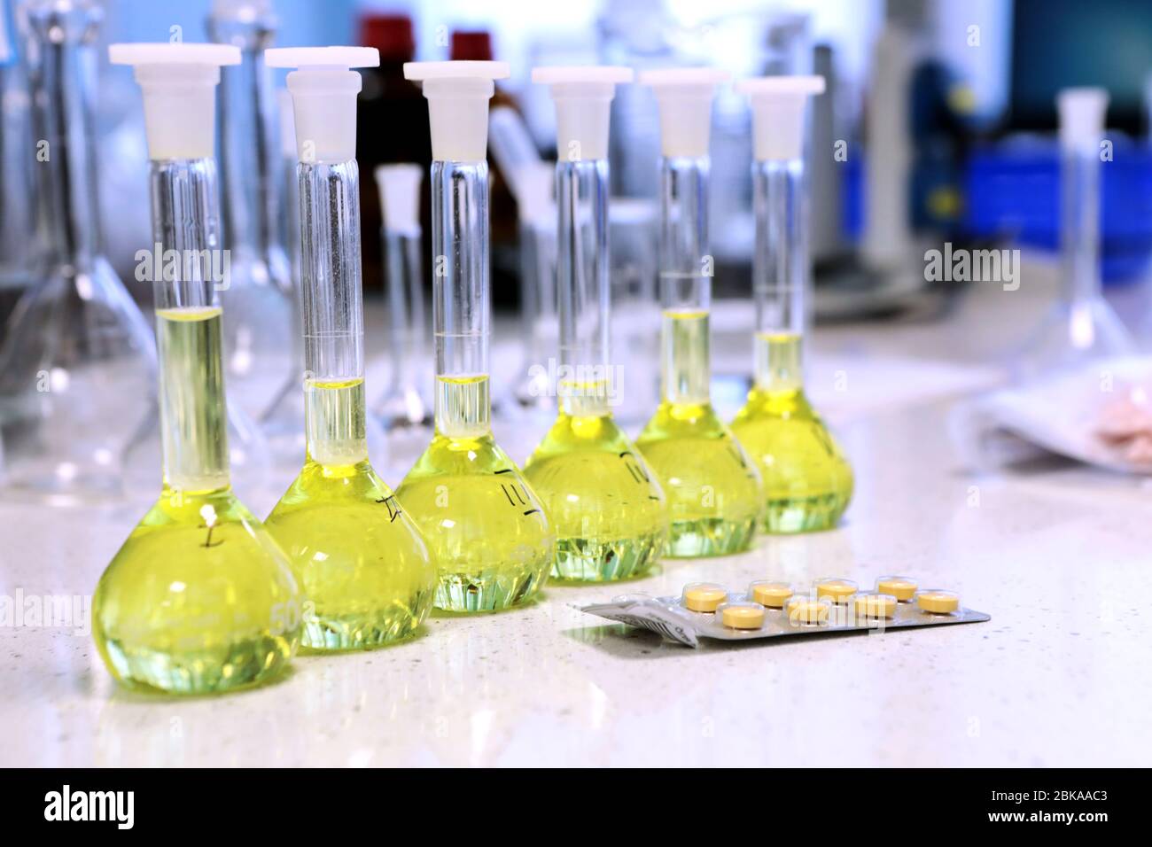 Conducting a chemical experiment in a laboratory. Colored flasks with ...
