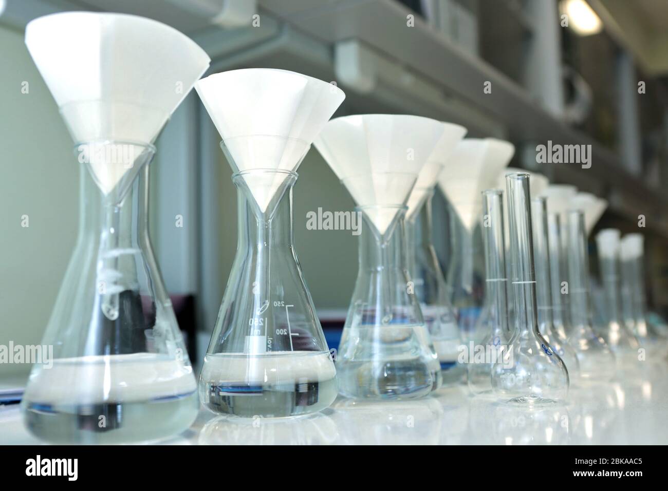 Conducting a chemical experiment in a laboratory. Colored flasks with ...