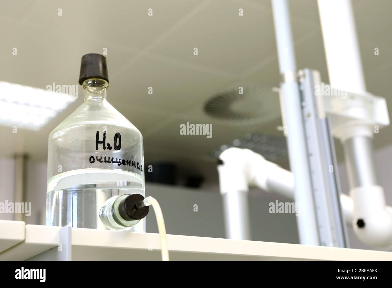 Conducting a chemical experiment in a laboratory. Colored flasks with ...