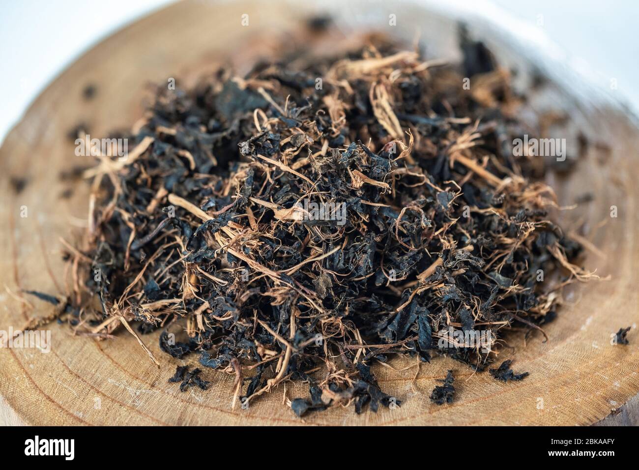 Dry black tea leaf in wooden platter. Traditional, healthy and organic ...