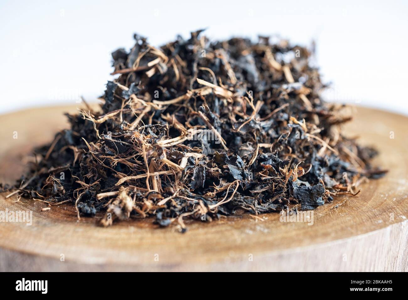 Dry black tea leaf in wooden platter. Traditional, healthy and organic ...