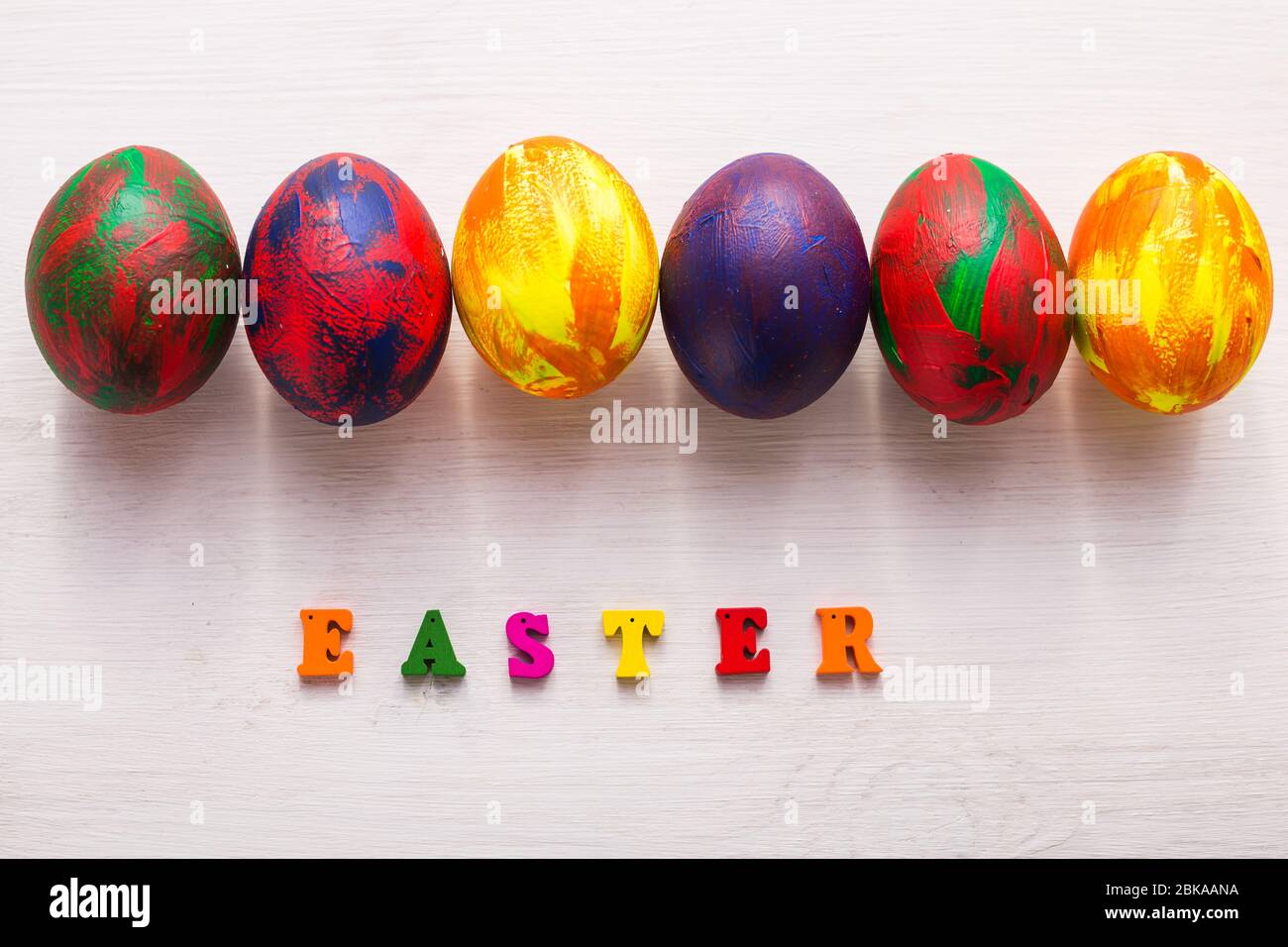 Multi-colored wooden letters making up the words happy easter and ...